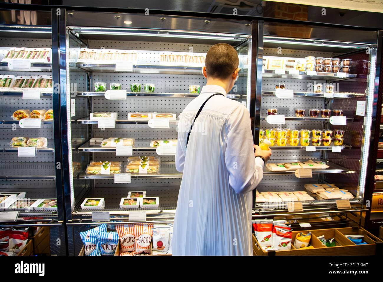 Person looking at the products on the shelves of a fast food shop in ...