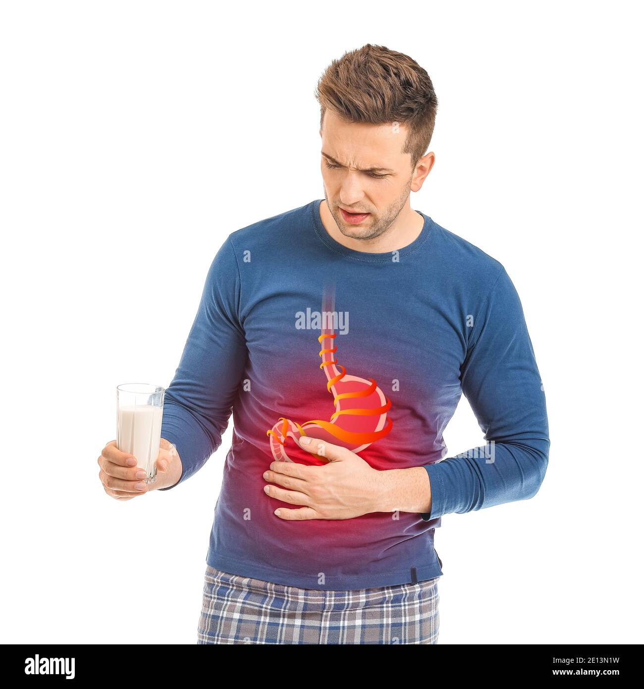 Young man with glass of milk suffering from heartburn on white ...