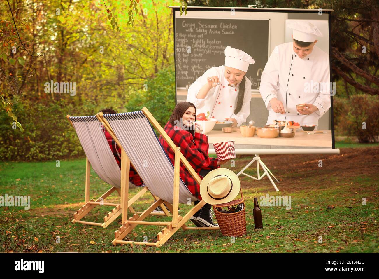 Young woman watching movie in outdoor cinema Stock Photo - Alamy