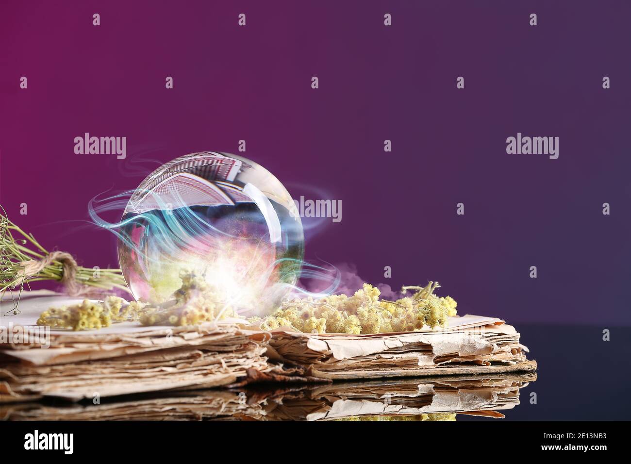 Crystal ball of fortune teller, herbs and spell book on color ...
