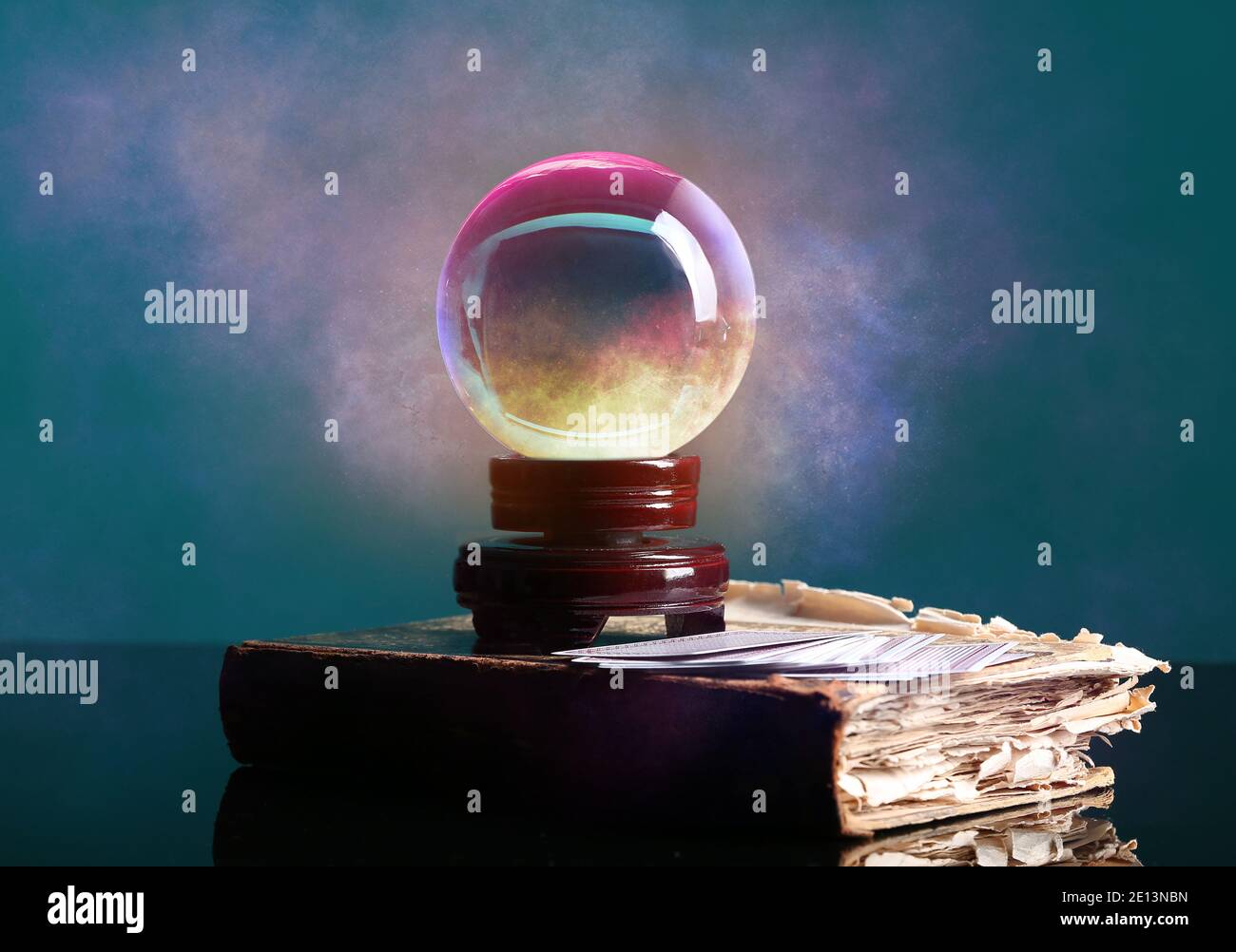Spell book, crystal ball of fortune teller and cards on table Stock ...