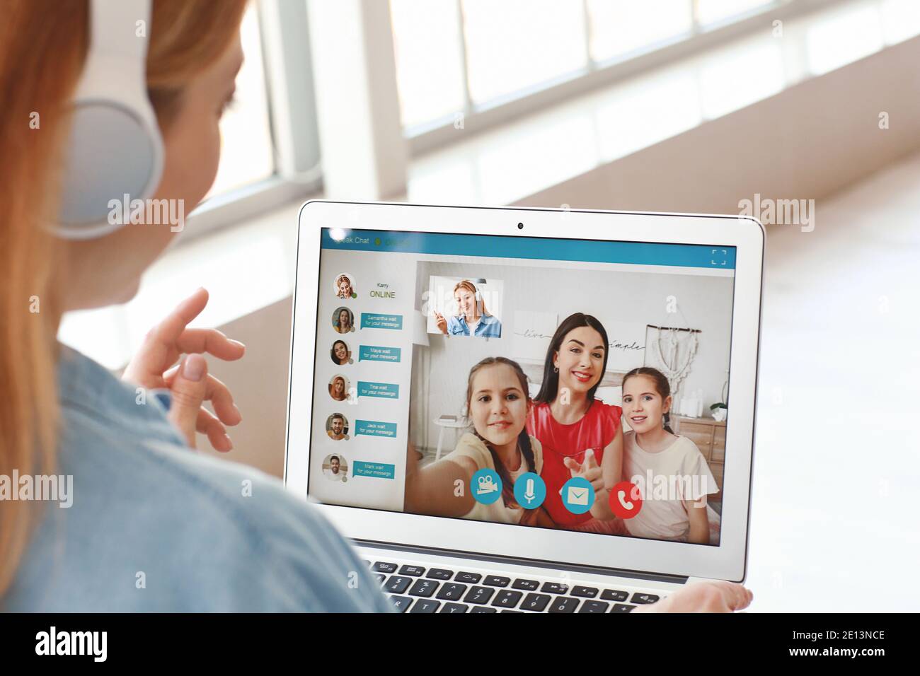 Mature woman video chatting with family at home Stock Photo - Alamy
