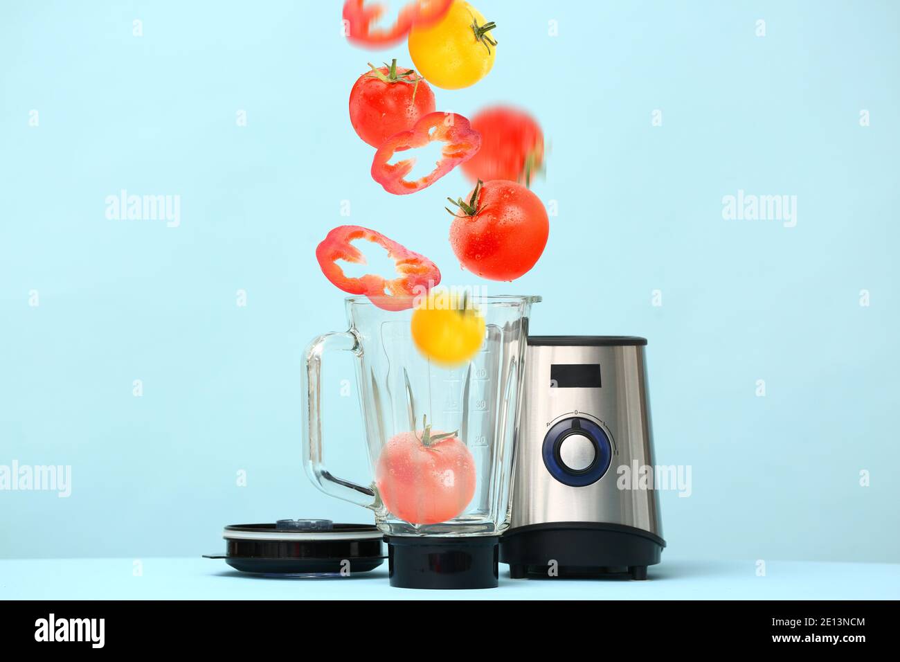 Blender with falling ingredients for healthy smoothie on color ...