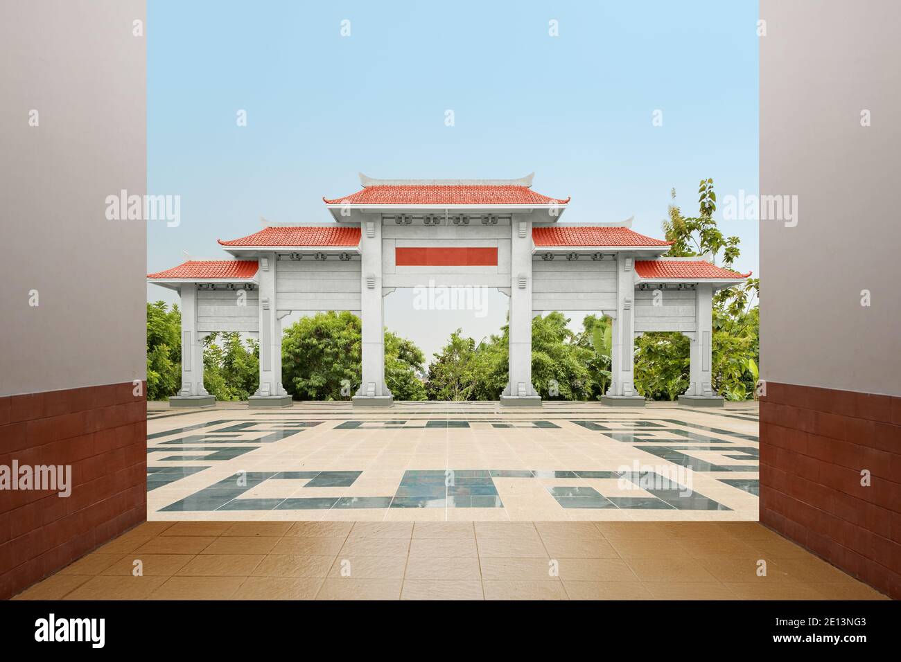 Chinese pavilion gate with red roof with garden view and a blue sky ...