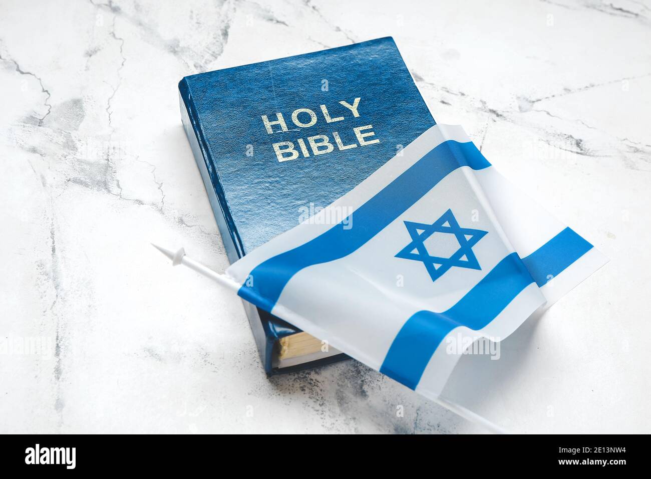 Holy Bible and flag of Israel on light background Stock Photo - Alamy