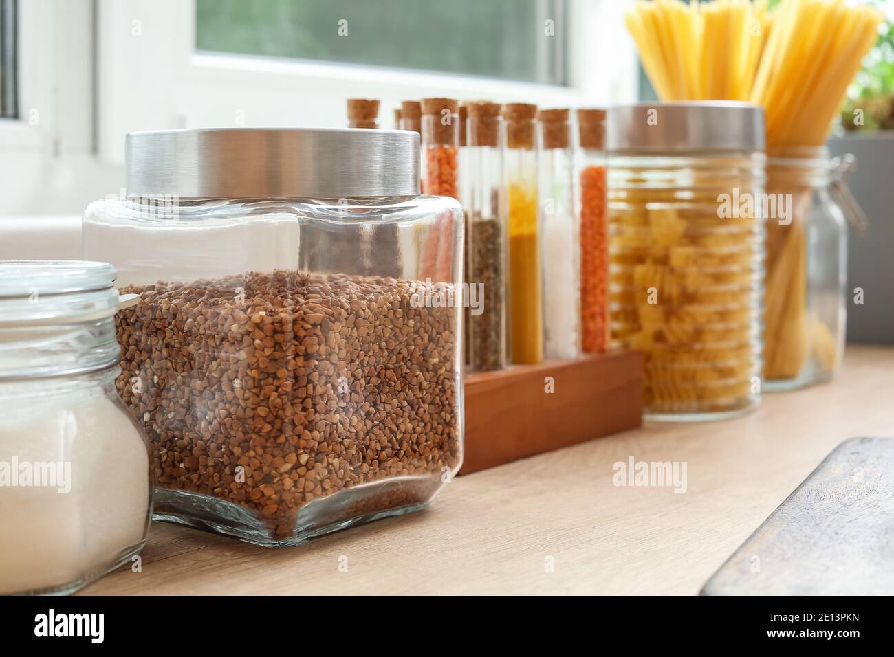 Glass jars with products and spices on kitchen counter Stock Photo - Alamy