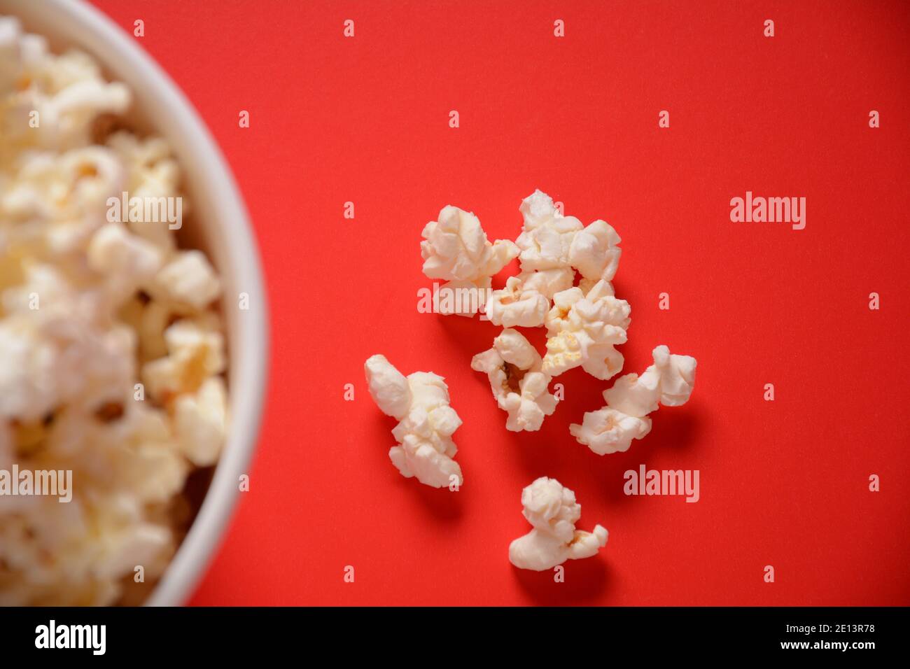 Buckets with delicious popcorn on red background. Spilled popcorn Stock ...