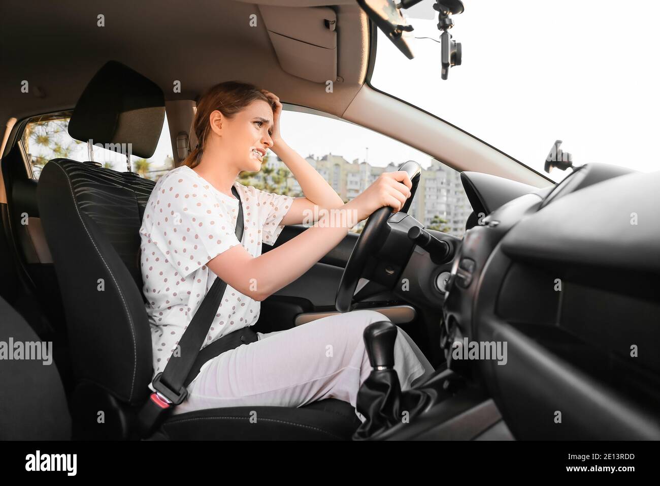 Stressed woman driving modern car Stock Photo - Alamy