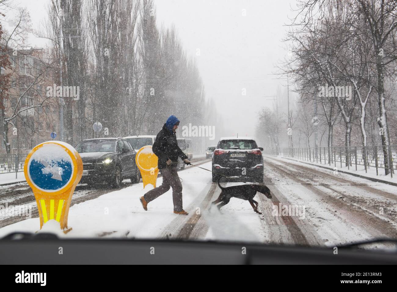 Snow covered road with pedestrian crossing hi-res stock photography and ...