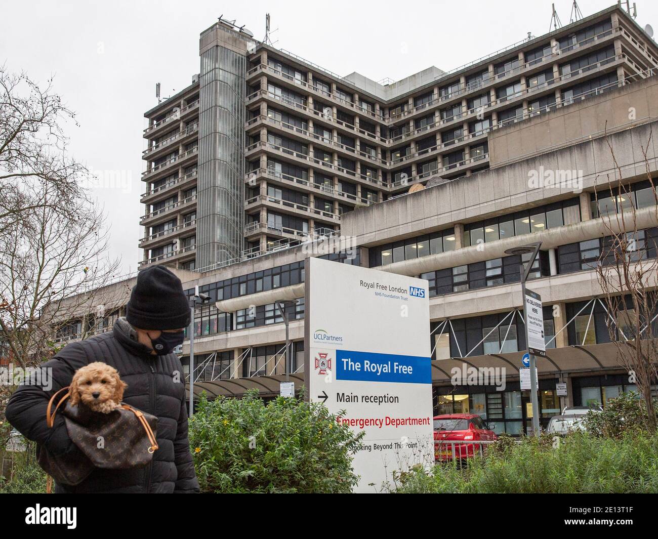 People wearing masks walk past the The Royal Free Hospital in north ...