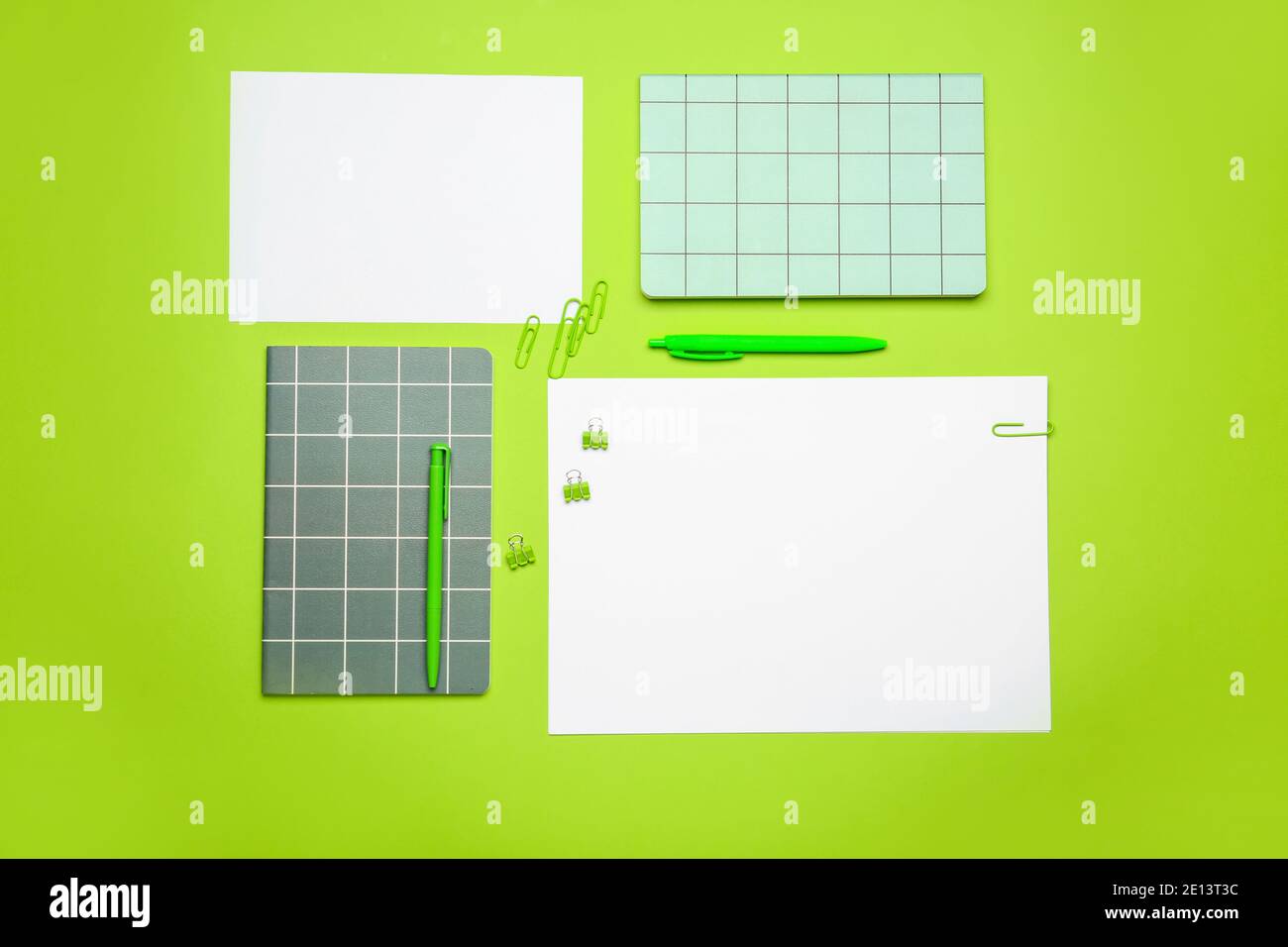 Composition with blank paper sheets and stationary on color background ...