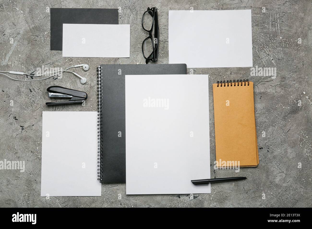 Composition with blank paper sheets and stationary on grunge background ...