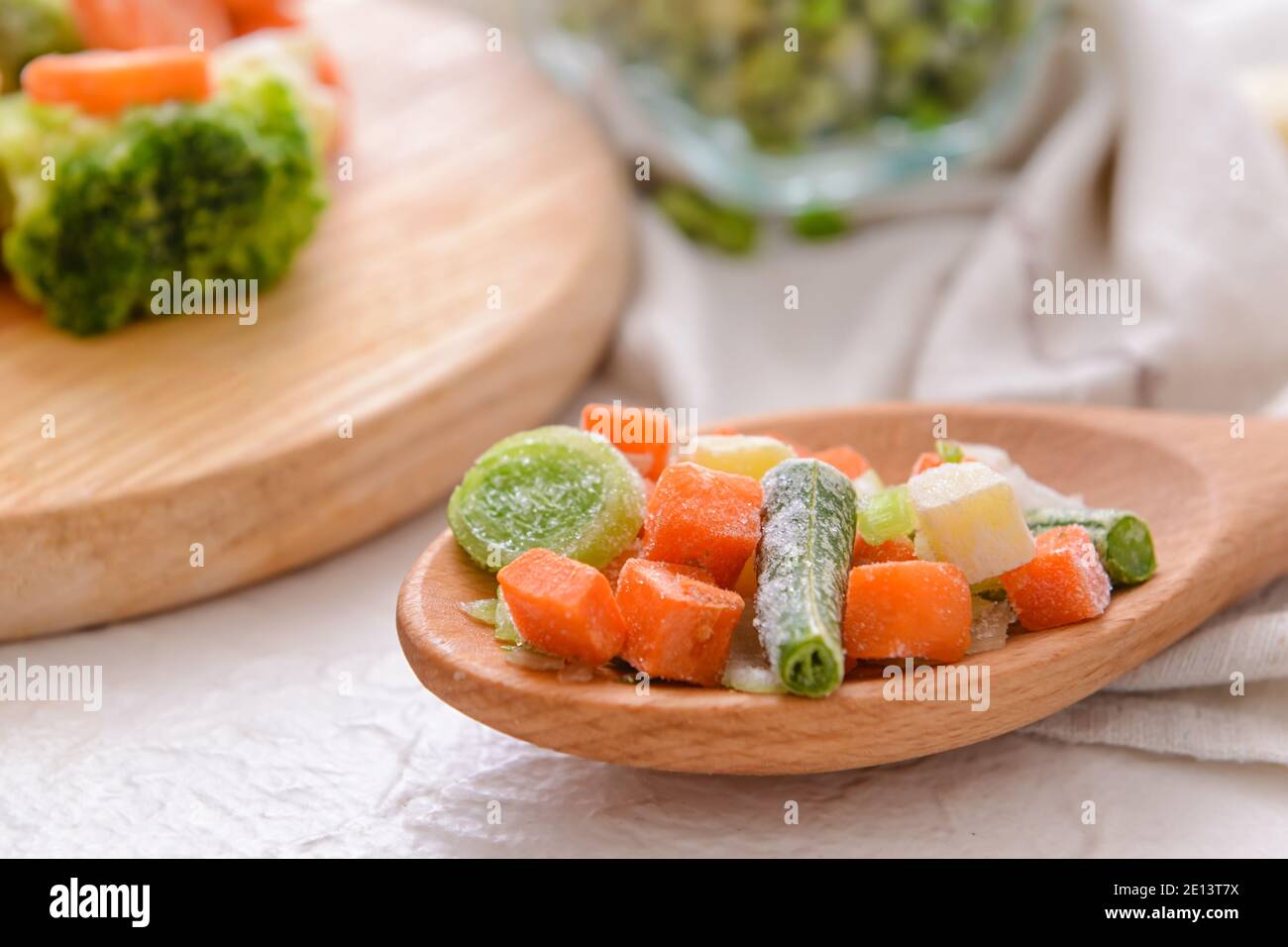 Frozen vegetables in spoon on light background Stock Photo - Alamy