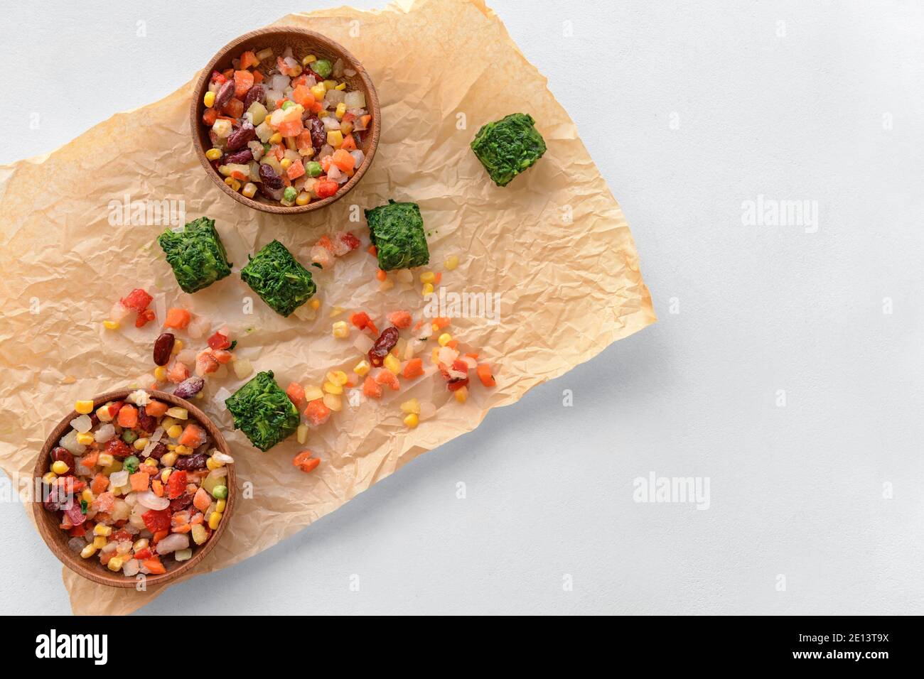Frozen vegetables in bowls on white background Stock Photo - Alamy