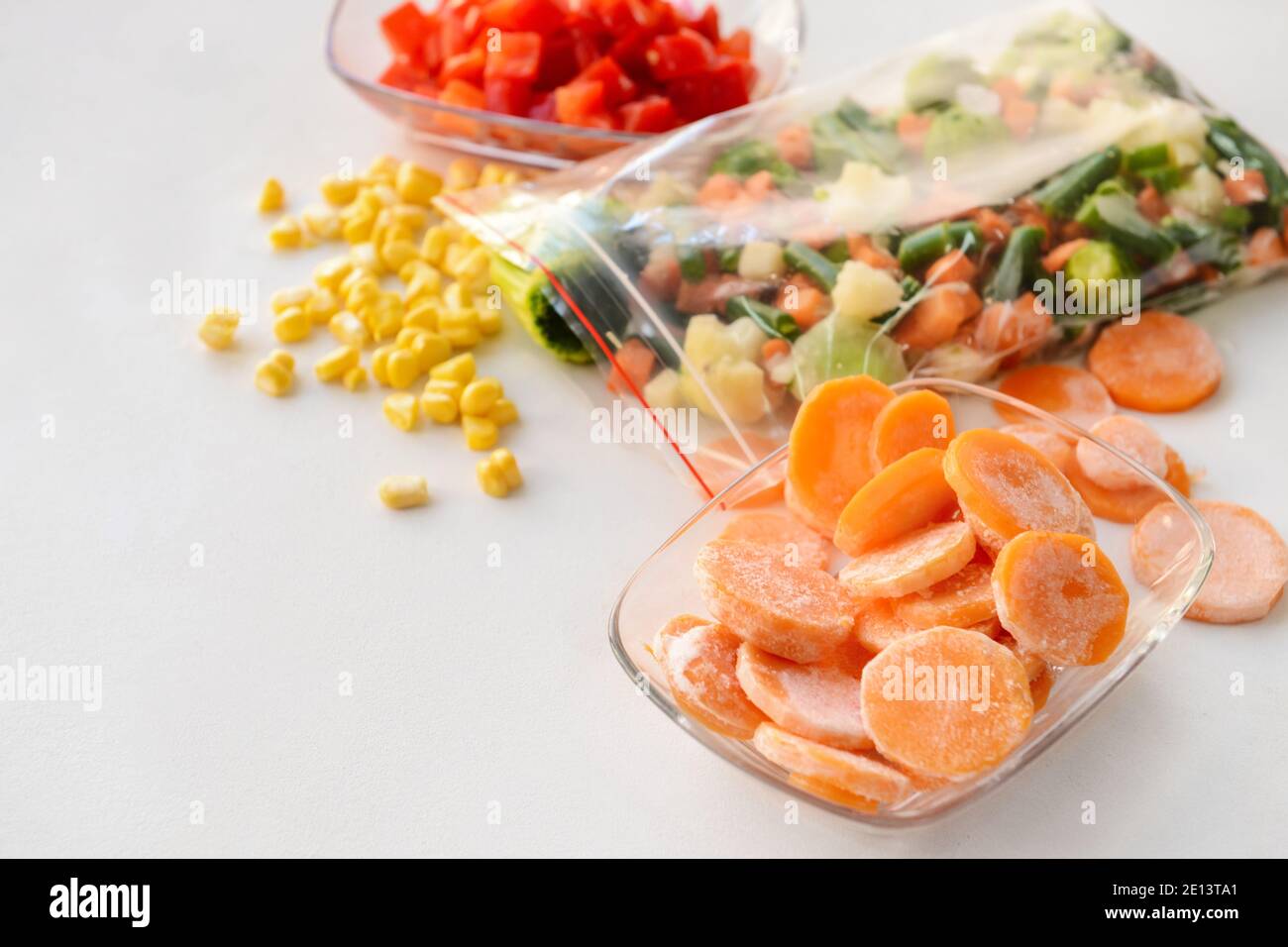 Frozen vegetables in bowl on white background Stock Photo - Alamy