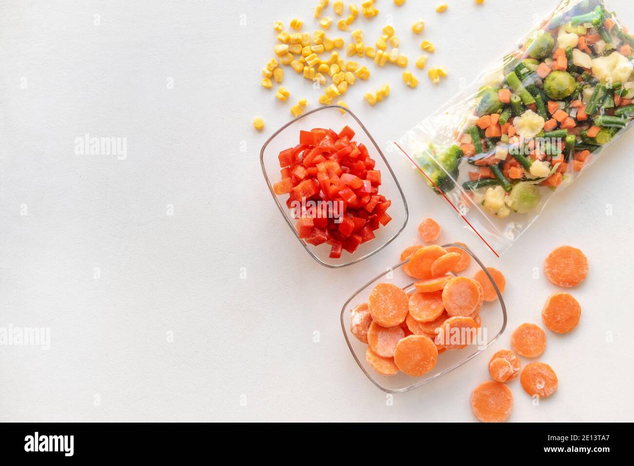 Frozen vegetables in bowl on white background Stock Photo - Alamy