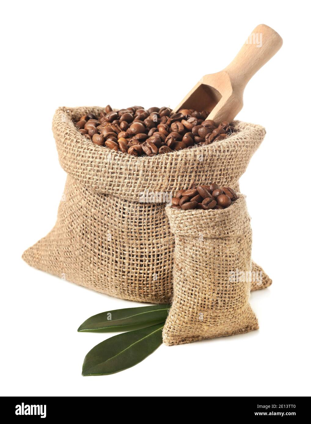 Bags with coffee beans and scoop on white background Stock Photo - Alamy