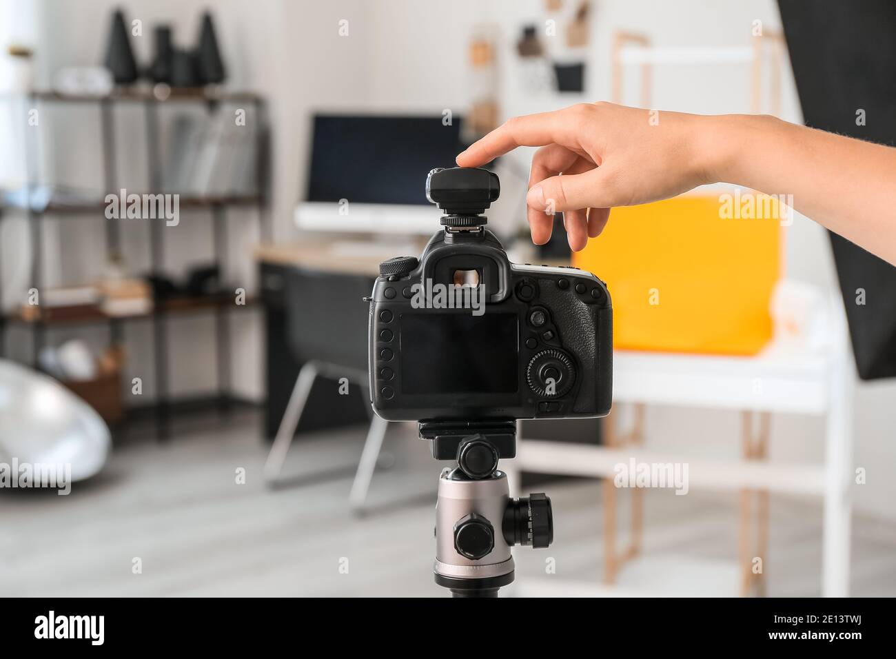 Female hand with modern photo camera in studio Stock Photo - Alamy