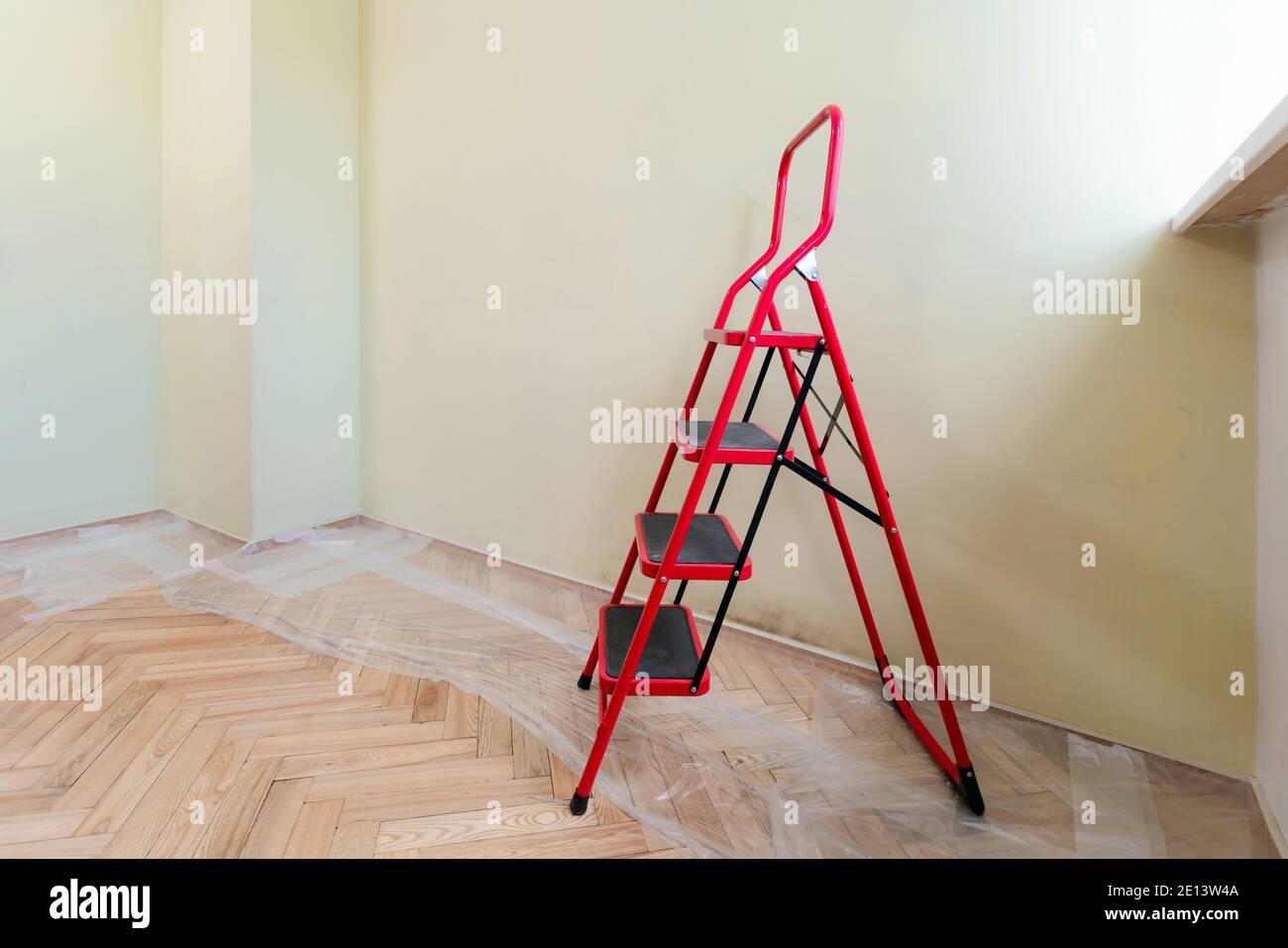 Empty room with a ladder before painting the walls. Cellophane ...