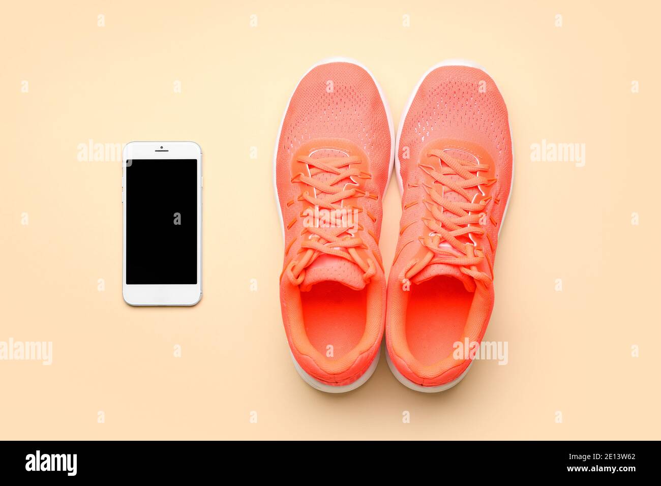 Sportive shoes and mobile phone on light background Stock Photo - Alamy