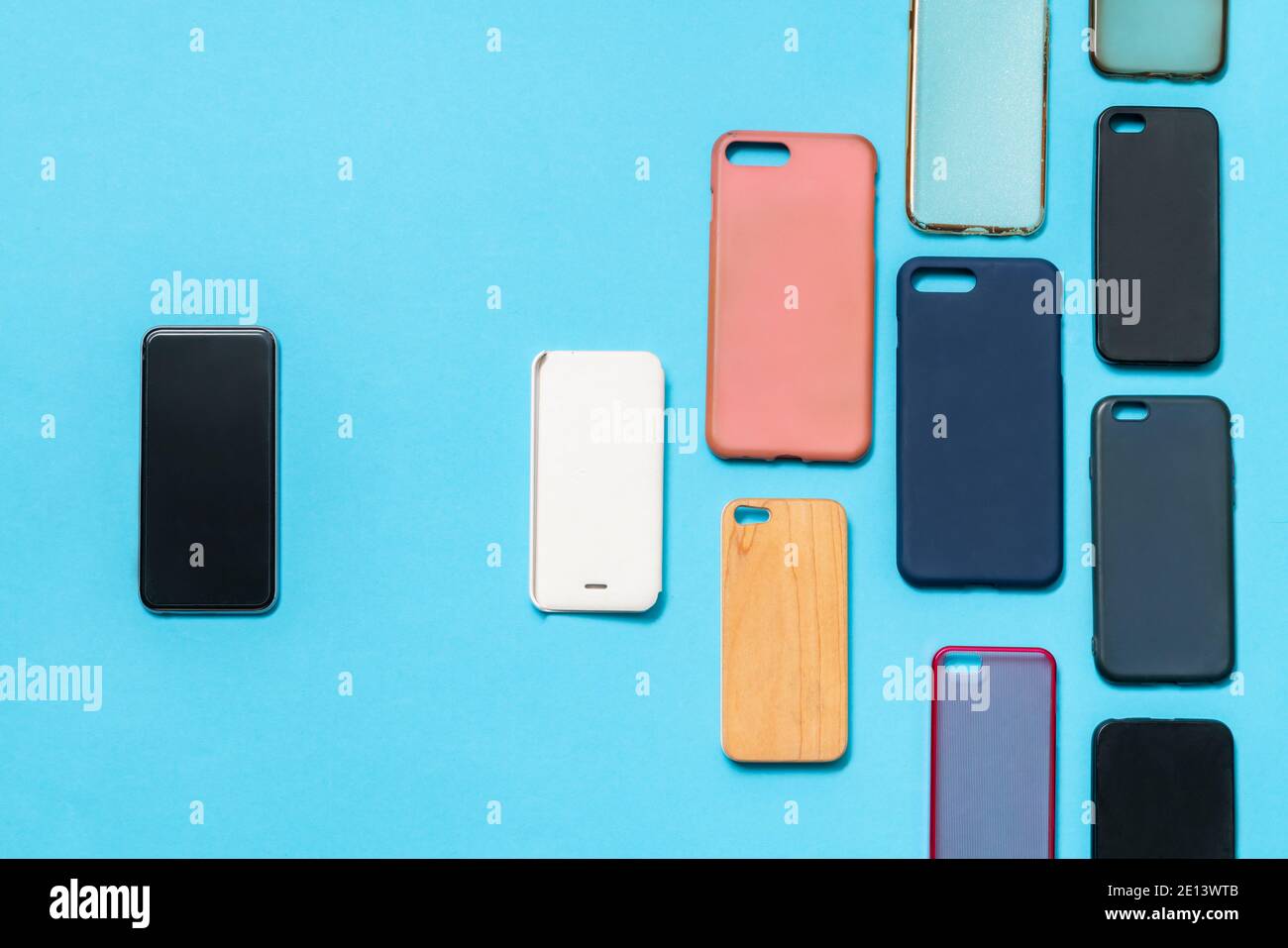 Pile of multicolored plastic back covers for mobile phones on blue ...