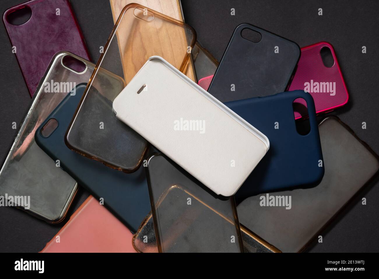 Pile of multicolored plastic back covers for mobile phones on black ...