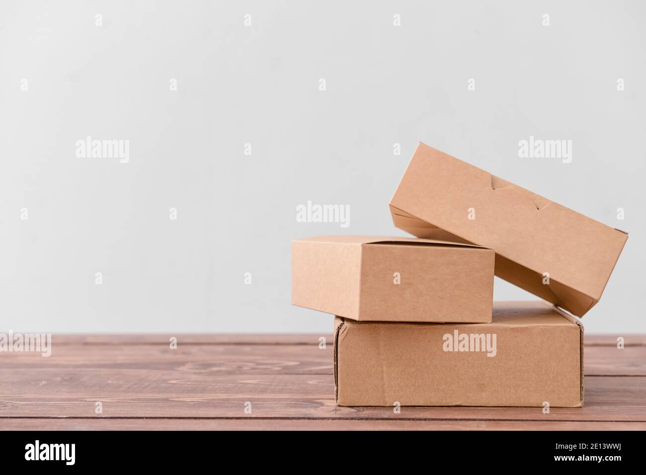 Blank cardboard boxes on wooden table Stock Photo - Alamy