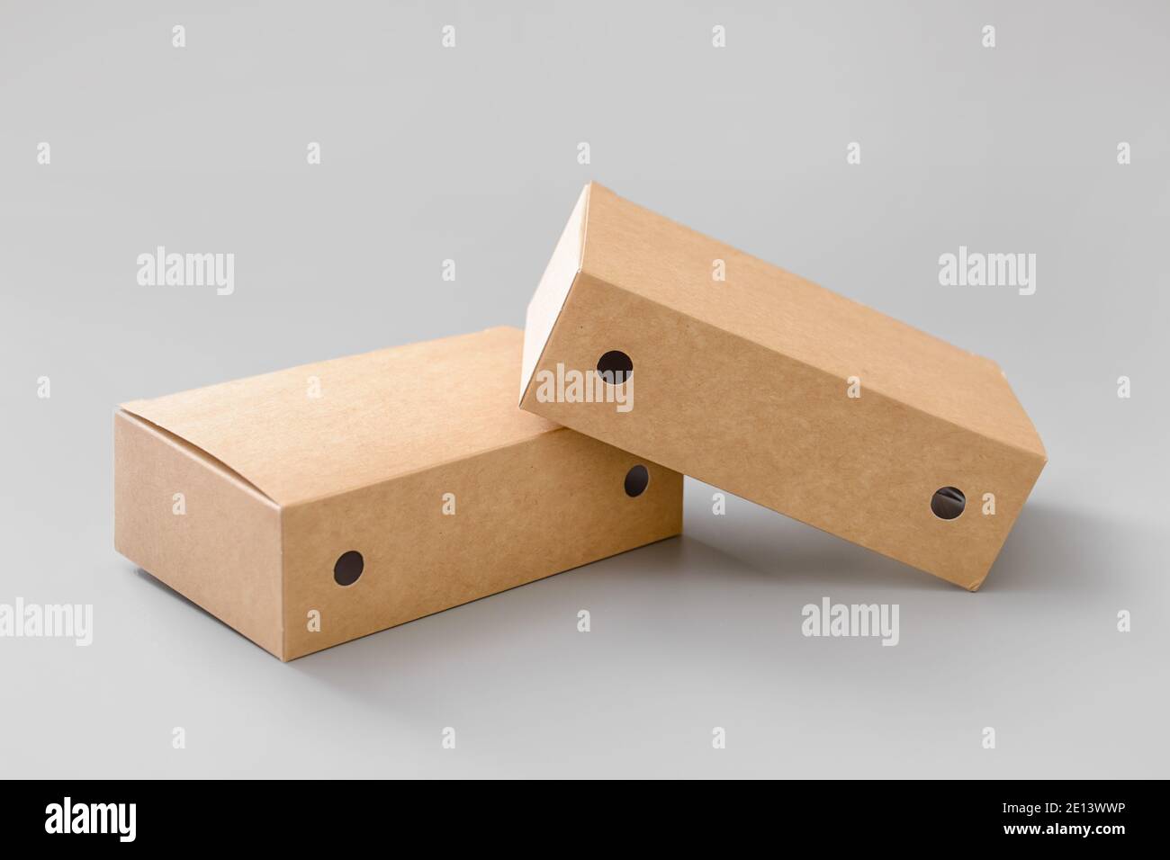 Blank cardboard boxes on light background Stock Photo - Alamy