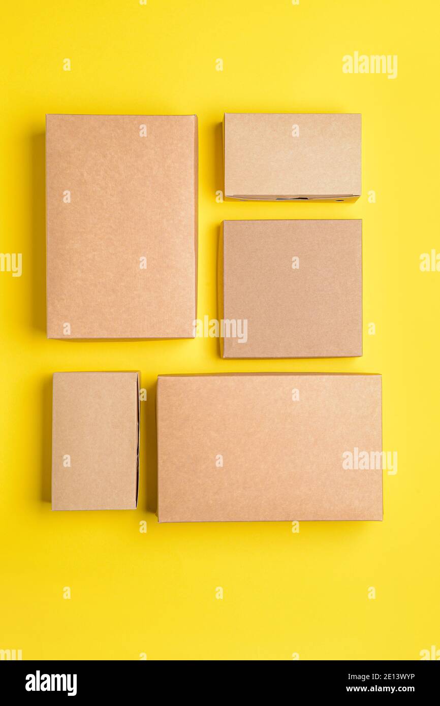 Blank cardboard boxes on color background Stock Photo - Alamy
