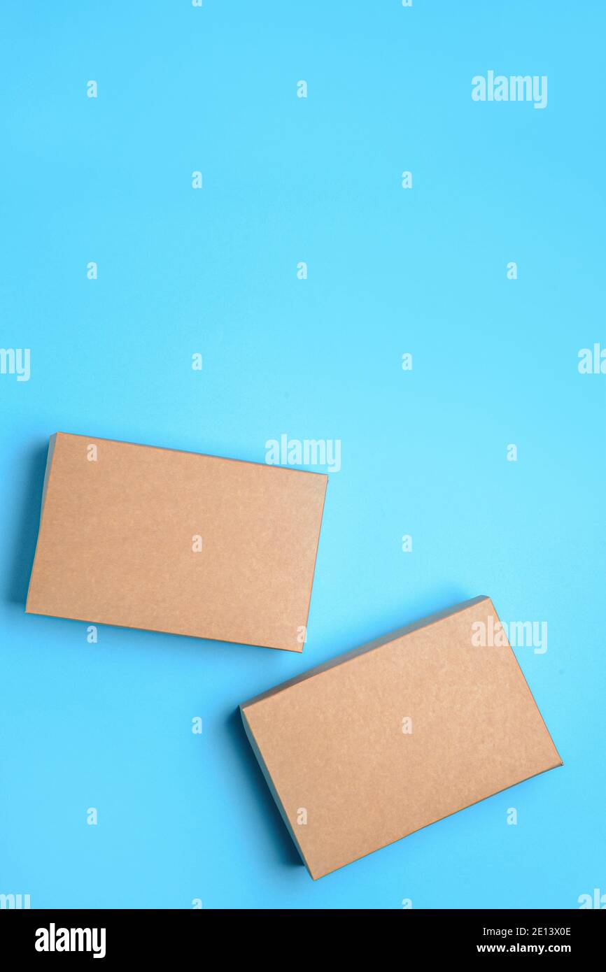 Blank cardboard boxes on color background Stock Photo - Alamy