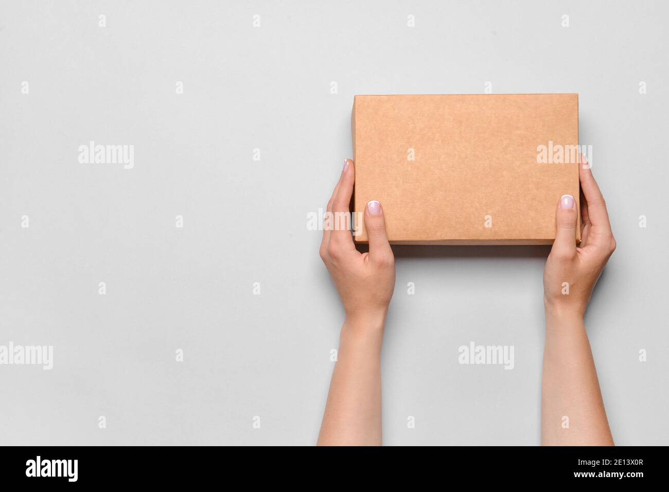 Hands with cardboard box on white background Stock Photo - Alamy