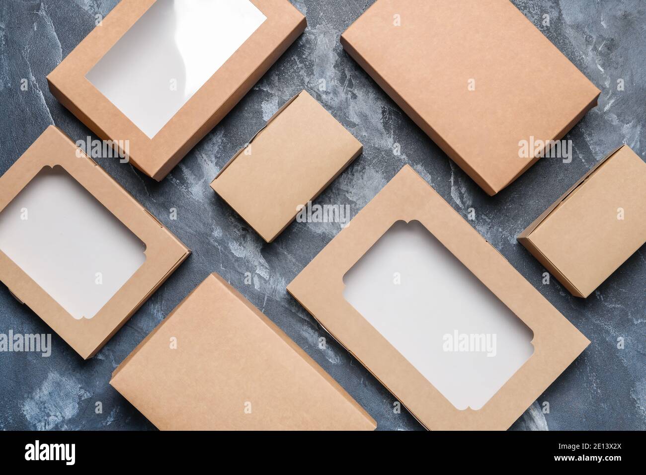 Blank cardboard boxes on color background Stock Photo - Alamy