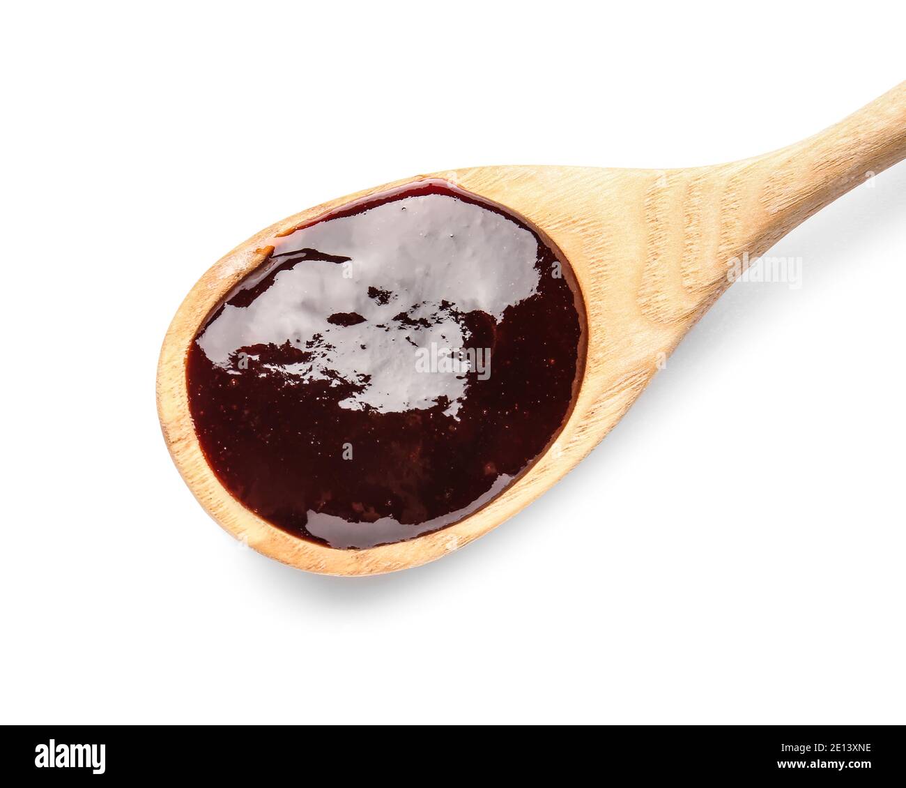 Wooden spoon with tasty plum jam on white background Stock Photo - Alamy
