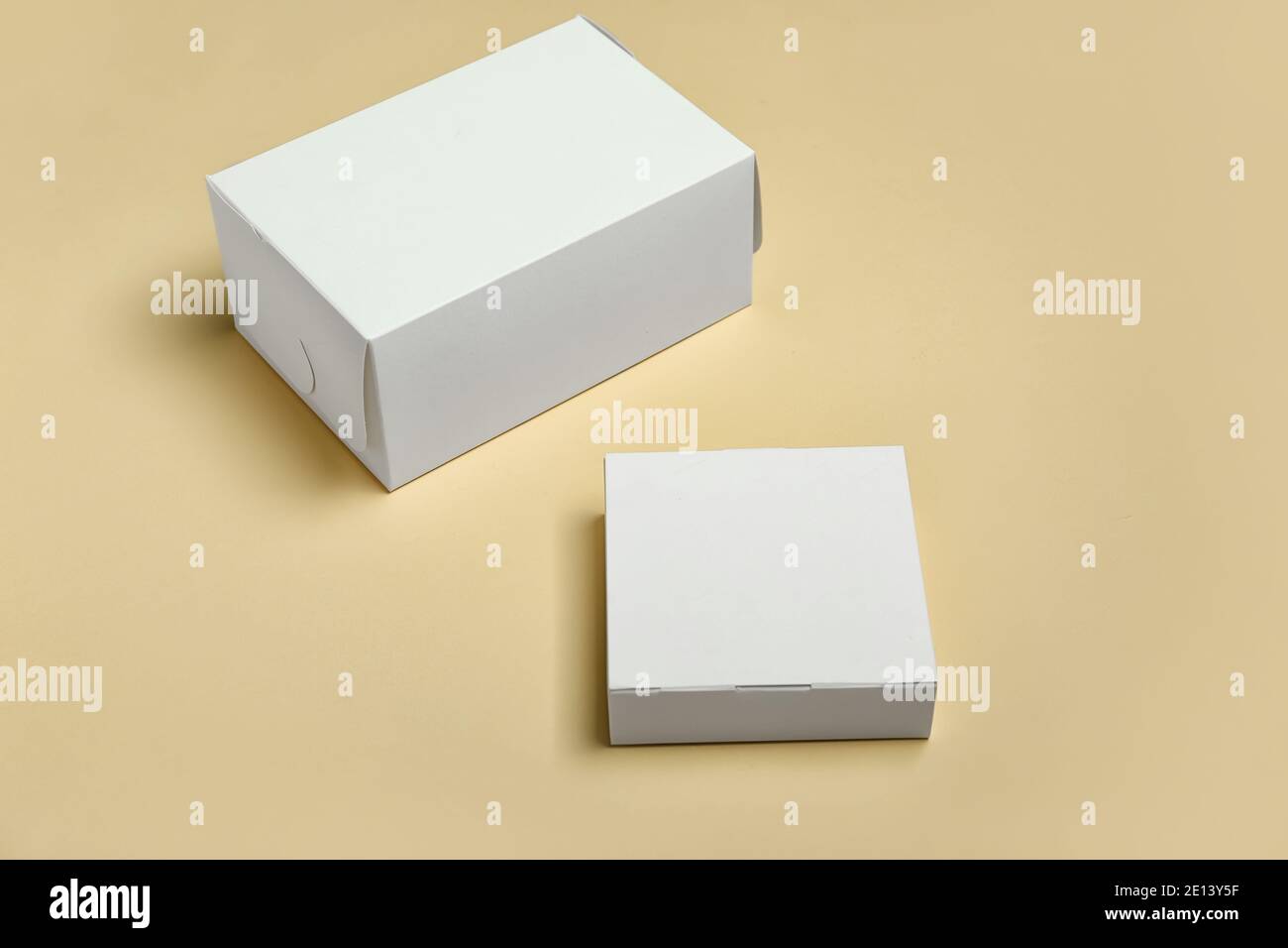 Blank cardboard boxes on color background Stock Photo - Alamy