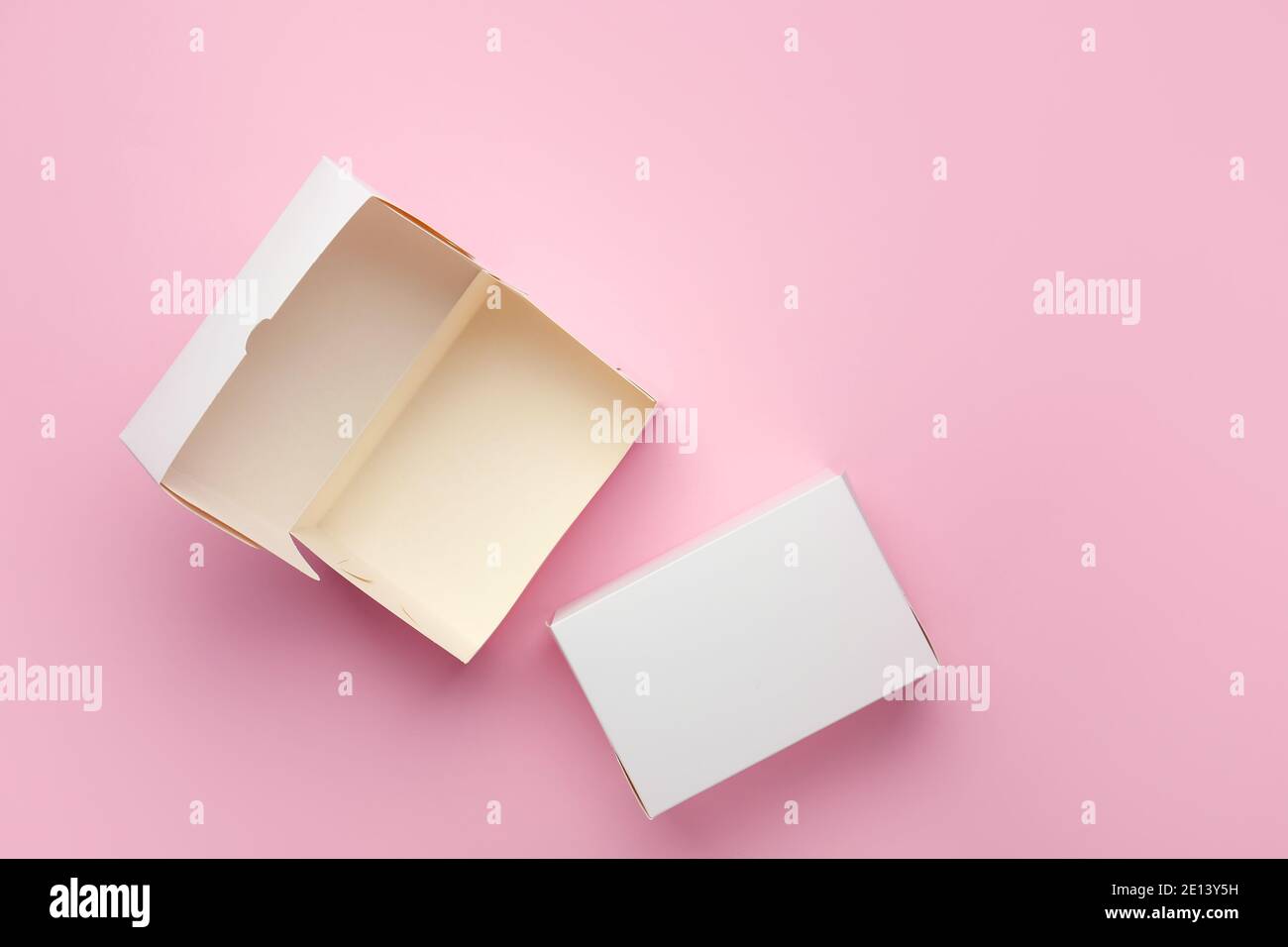 Blank cardboard boxes on color background Stock Photo - Alamy