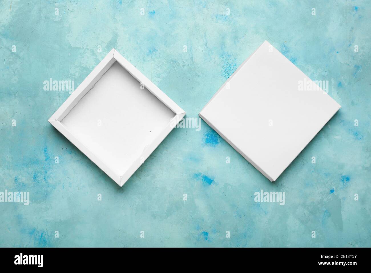 Blank cardboard boxes on color background Stock Photo - Alamy
