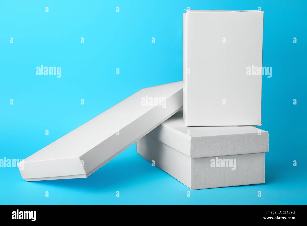 Blank cardboard boxes on color background Stock Photo - Alamy
