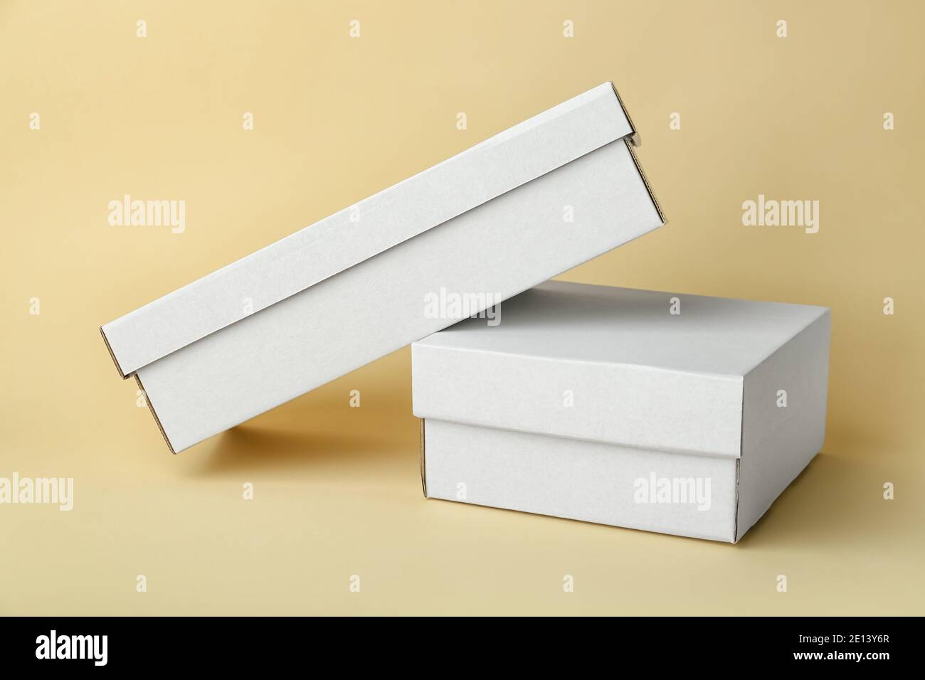 Blank cardboard boxes on color background Stock Photo - Alamy