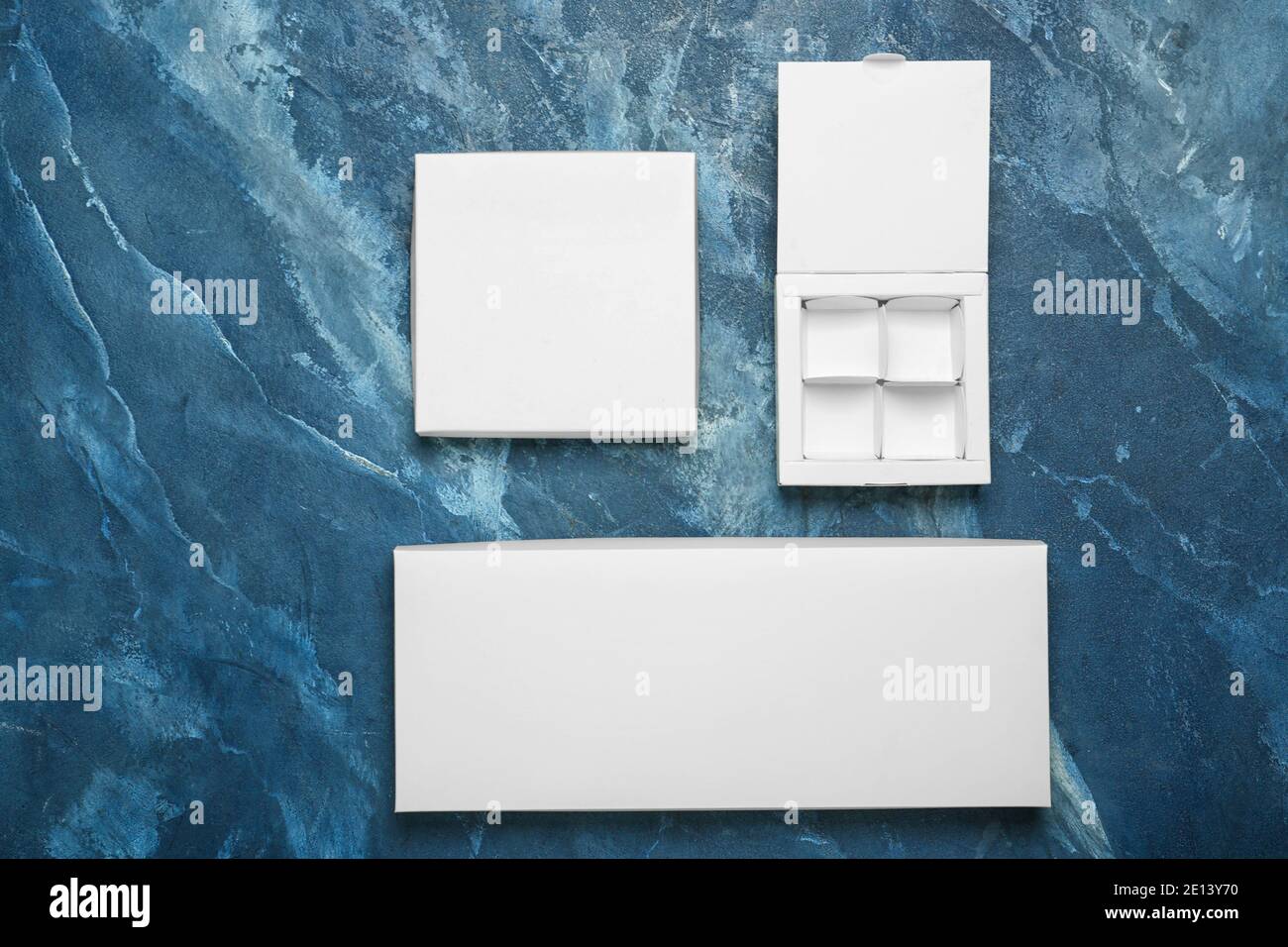 Blank cardboard boxes on color background Stock Photo - Alamy