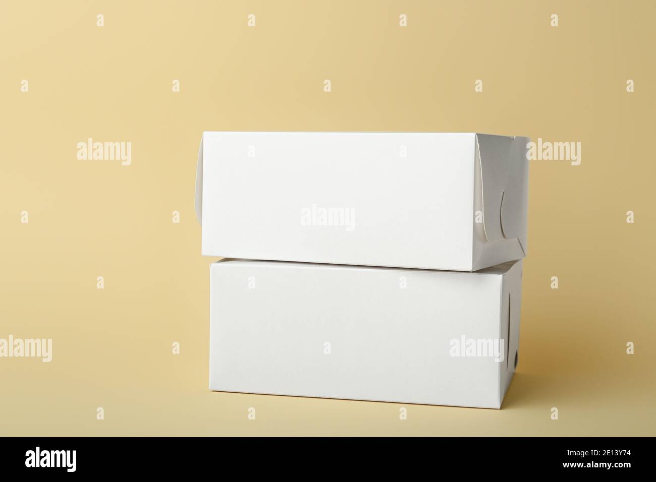 Blank cardboard boxes on color background Stock Photo - Alamy