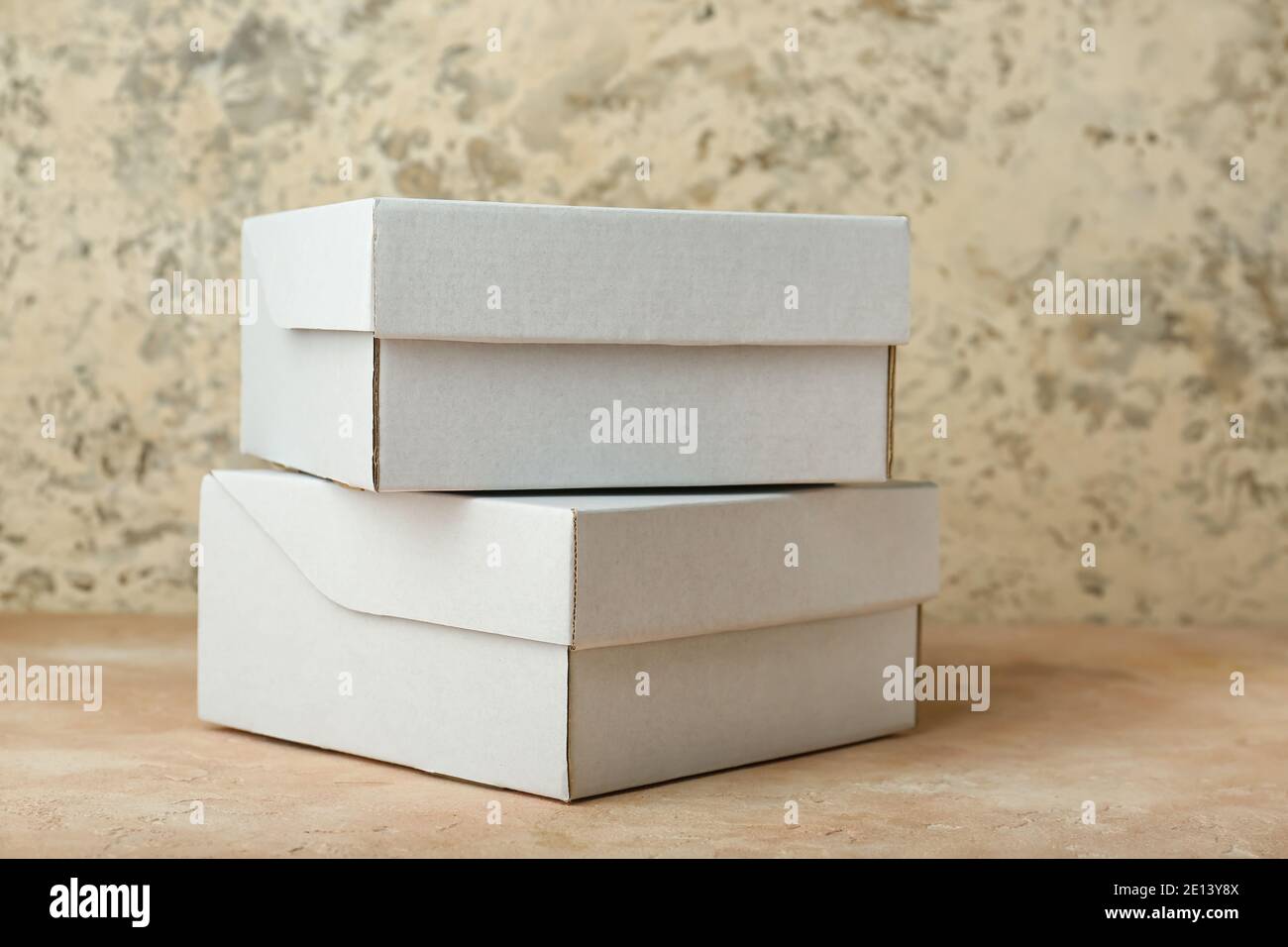 Blank cardboard boxes on color background Stock Photo - Alamy