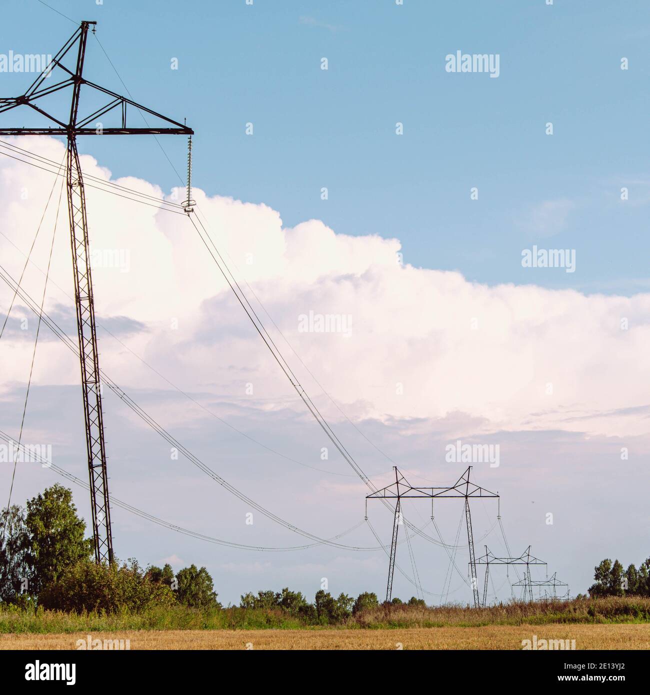 Farm field with power lines on horizon. Energy transportation Stock ...