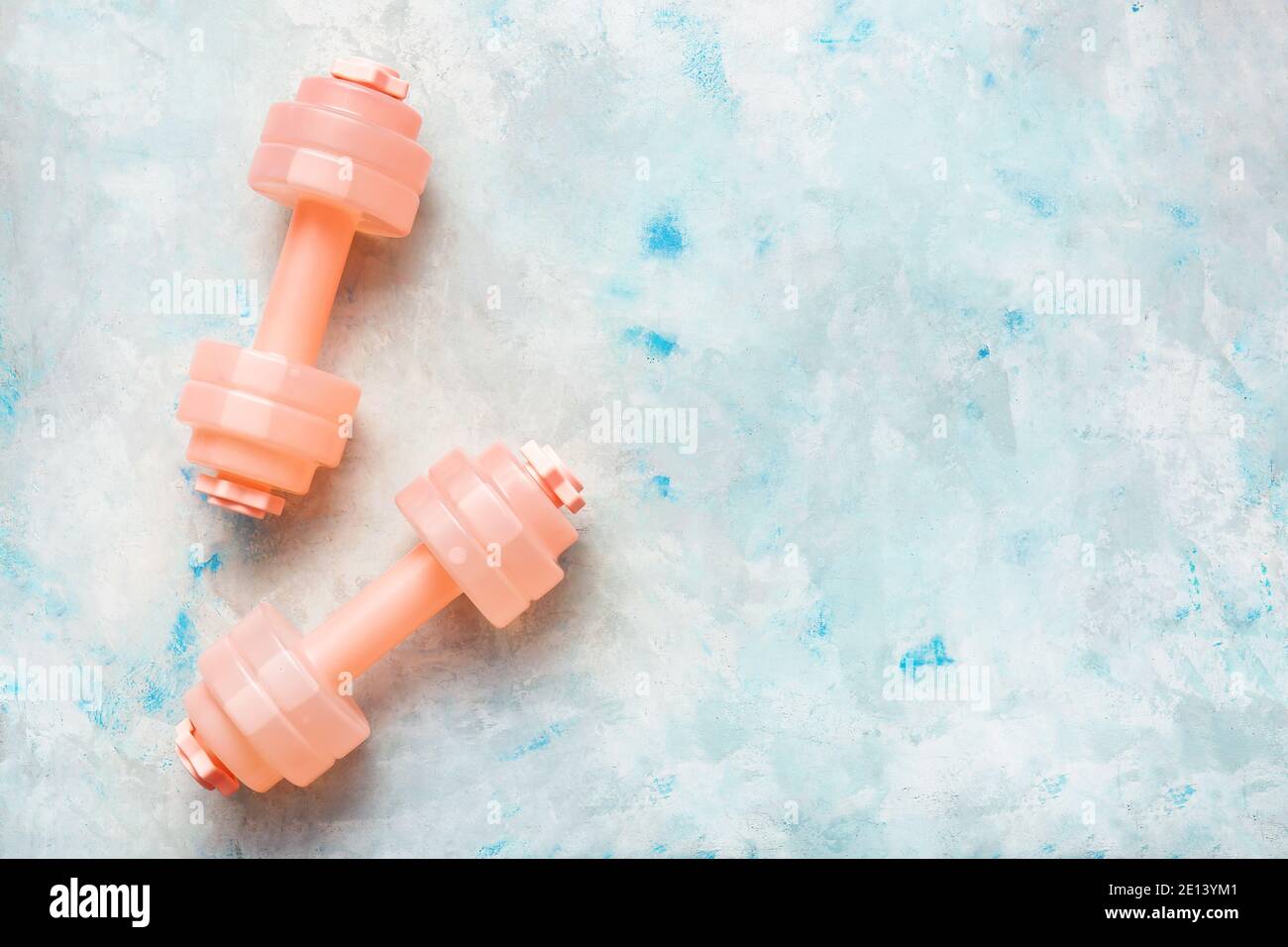 Stylish dumbbells on light background Stock Photo - Alamy