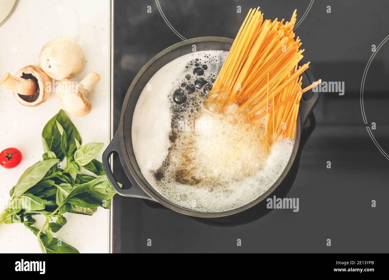 Pasta boiling in cooking pot on electric stove Stock Photo - Alamy