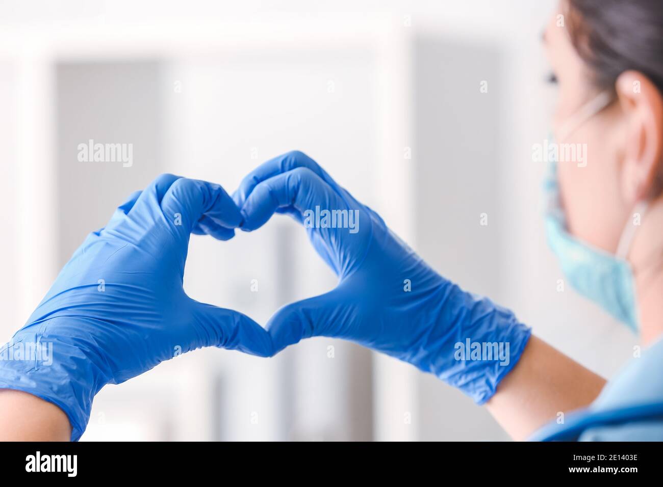 Female doctor showing heart shape with hands, closeup Stock Photo - Alamy
