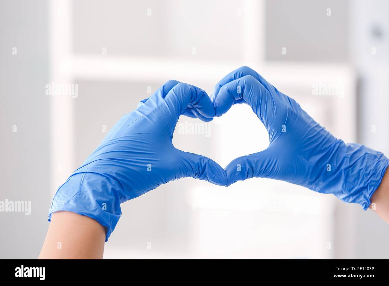 Female doctor showing heart shape with hands, closeup Stock Photo - Alamy