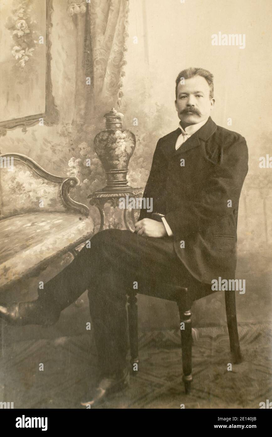 Germany - CIRCA 1910-20s: Rich man sitting in studio. Vintage cabinet ...