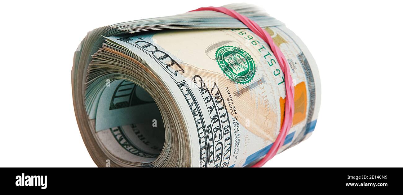 Isolated roll of dollars. A large roll of hundred-dollar bills lies on ...