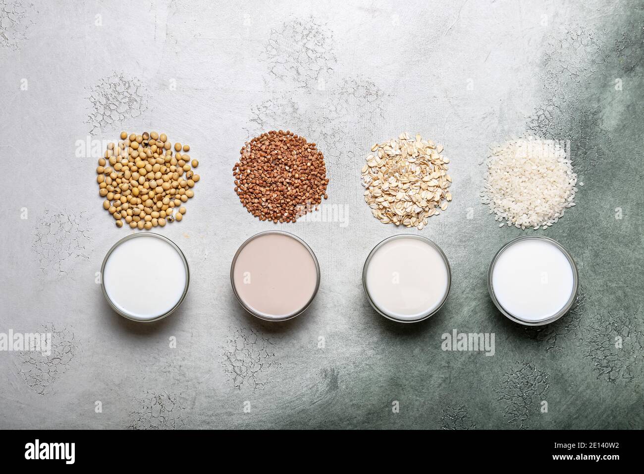 Glasses of different milk on color background Stock Photo - Alamy