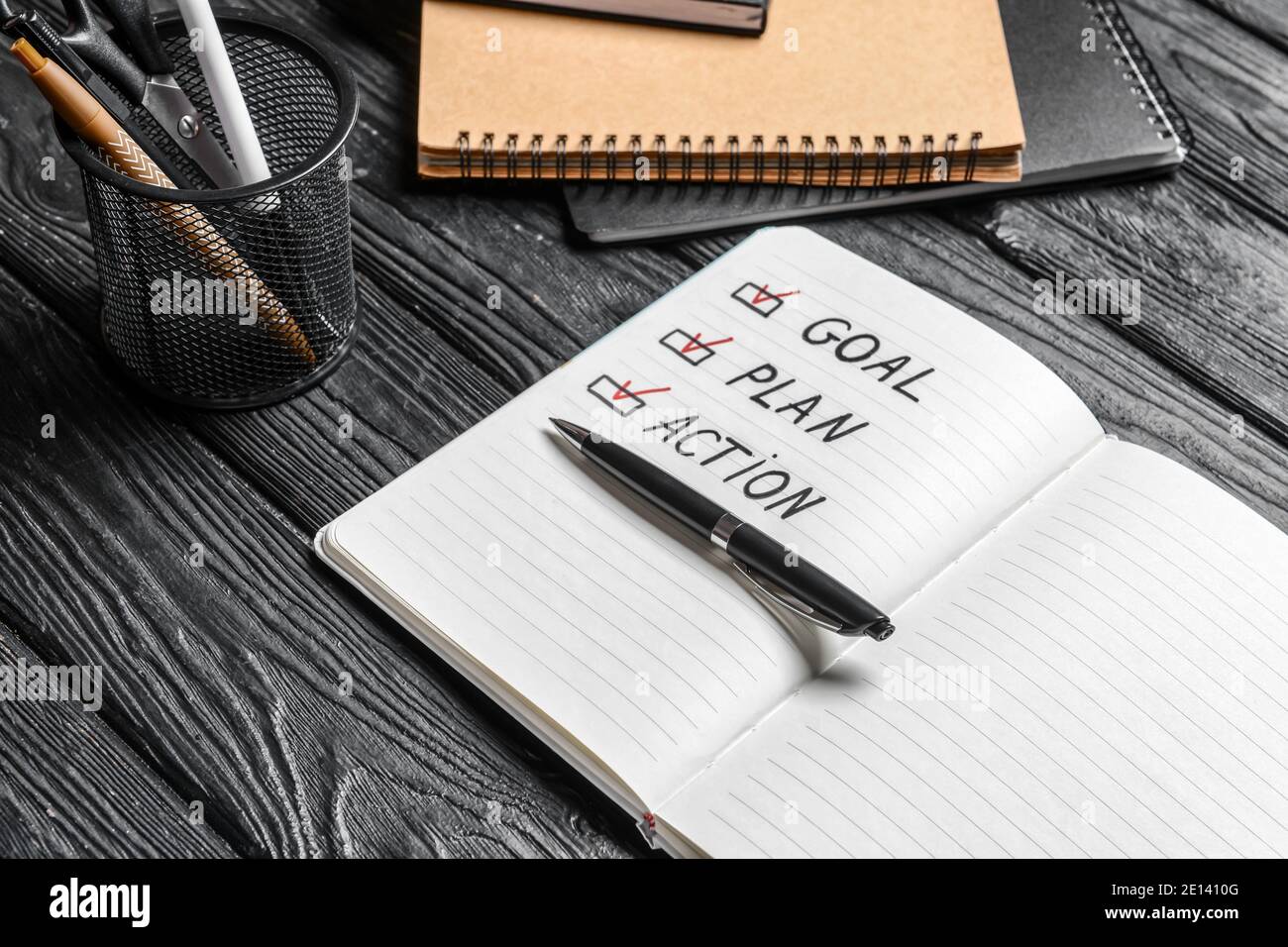 Text GOAL PLAN ACTION in notebook and pen on wooden background Stock ...